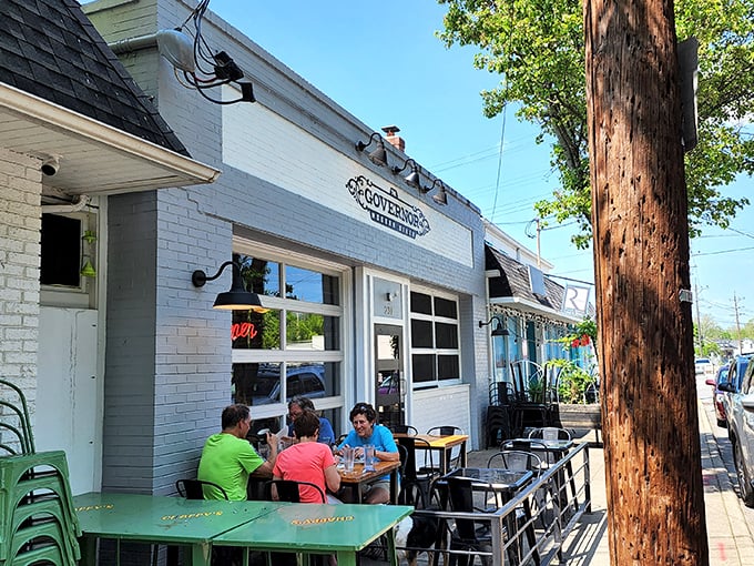 Sun-drenched sidewalk dining where conversations flow as freely as the coffee, proving some of life's best moments happen at small tables.