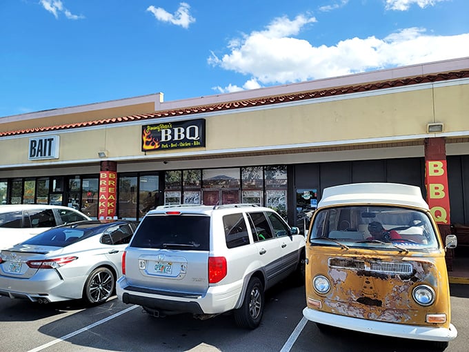 The unassuming strip mall exterior hides BBQ greatness, complete with a vintage VW bus that's seen more adventures than most of us. 