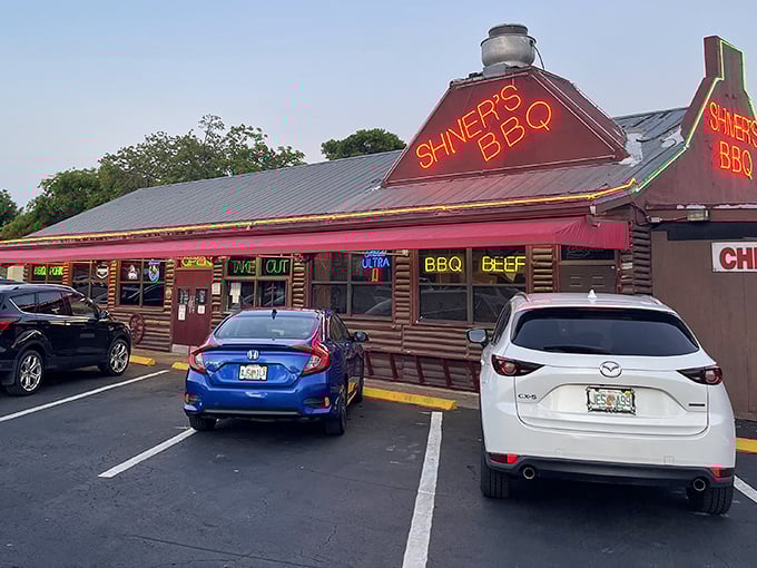 The neon glow of Shiver's BBQ sign beckons hungry travelers like a smoky lighthouse on the edge of the Everglades. Florida's barbecue beacon.