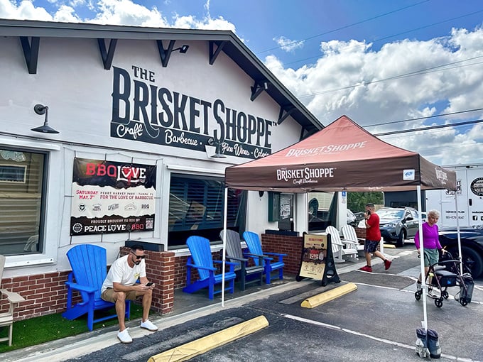 Welcome to barbecue heaven, where blue Adirondack chairs and a cheerful awning invite you to stay awhile and feast.