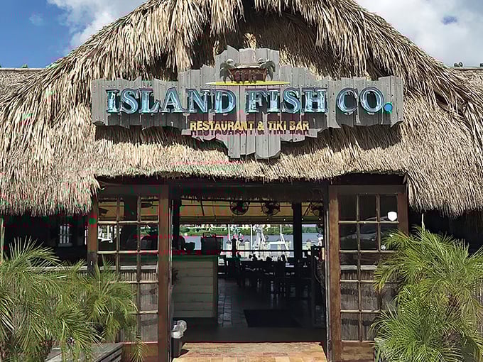 Sunlight dances through palm fronds as you approach this Marathon landmark, where fresh seafood and island vibes await just beyond those wooden doors.