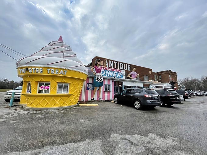 The Pink Elephant Antique Mall announces itself with all the subtlety of a carnival barker – complete with giant ice cream cone and retro roadside charm that screams "STOP YOUR CAR NOW!"