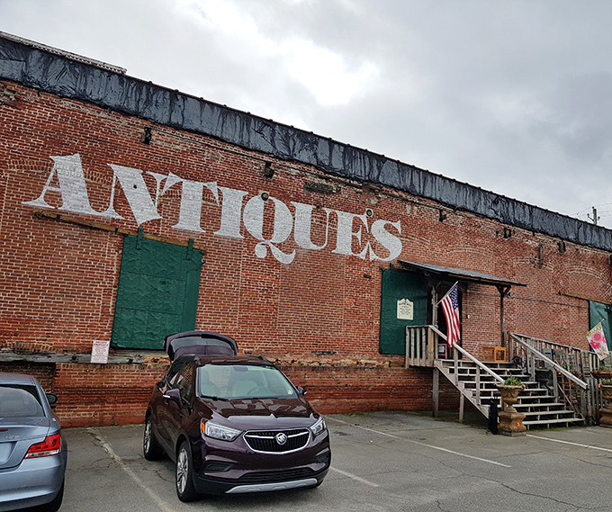 The brick exterior boldly announces "ANTIQUES" like a time-travel invitation written in giant letters. No DeLorean required—just an appreciation for history and comfortable walking shoes.