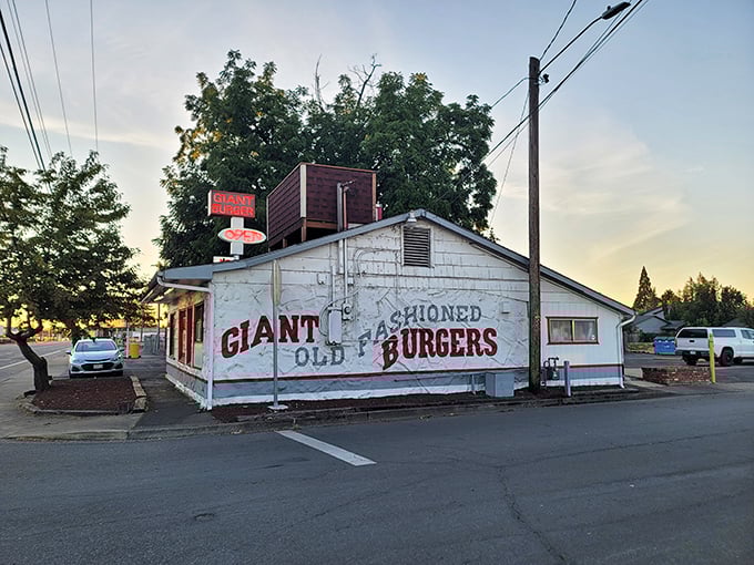 The white building with bold red lettering stands as a time capsule of American dining. No frills, just the promise of burger perfection.
