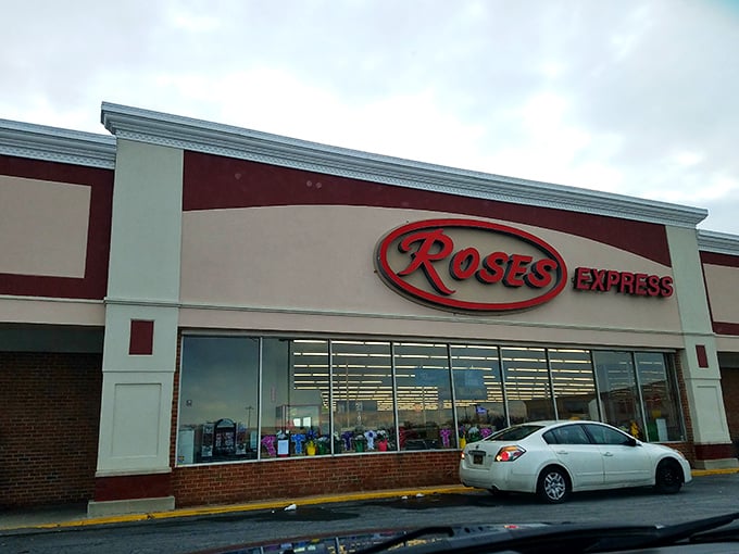 The iconic red Roses Express sign beckons bargain hunters like a retail lighthouse guiding ships to shore—promising treasures within those unassuming walls.