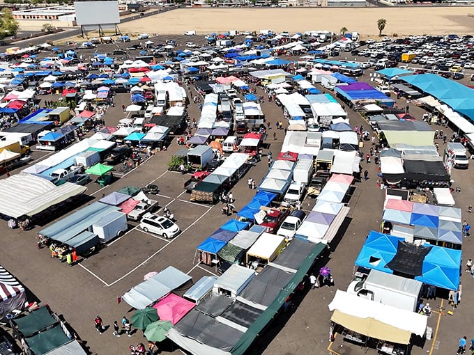 A treasure hunter's paradise from above! The Glendale Public Market sprawls across acres of asphalt, a colorful patchwork of possibility under the Arizona sky.