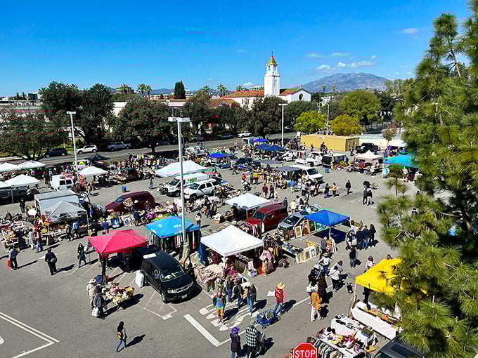 Aerial view of treasure hunters navigating a sea of canopies and tables, with the iconic Pasadena architecture creating the perfect backdrop for bargain quests.