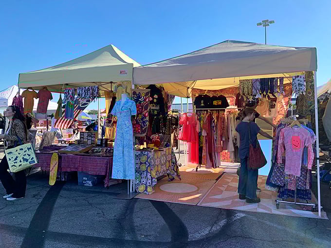 The treasure hunt begins! Colorful racks spill out beneath sunlit canopies, where early birds scour the stalls for vintage gems and one-of-a-kind finds.