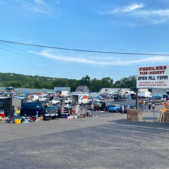The sprawling landscape of Peddlers Flea Market under Cincinnati's blue sky – where one person's castoffs become another's treasures every weekend.