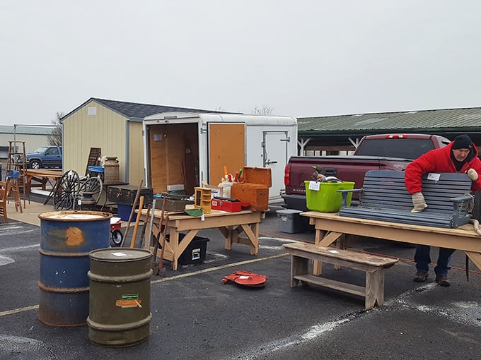 The tailgate economy in full swing! One vendor's truck becomes a showroom of possibility, where porch swings and oil drums await their second chance.