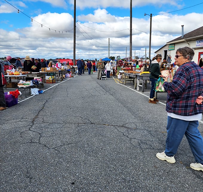 The treasure hunt begins under white canopy tents, where one person's castoffs become another's prized possessions. Every table tells a different story.