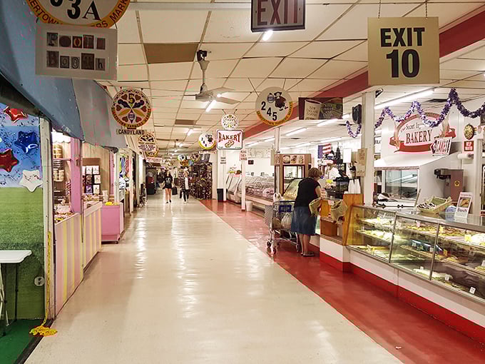 The main corridor of Q-Mart stretches before you like a treasure map, with the bakery's siren call beckoning from the right.