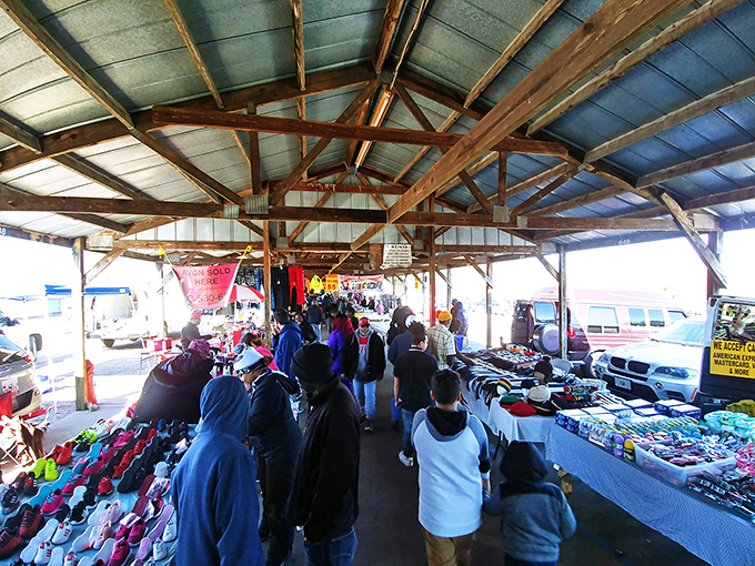 The covered pavilions at US 1 Metro Flea Market buzz with weekend energy as shoppers hunt for treasures among tables laden with colorful merchandise.