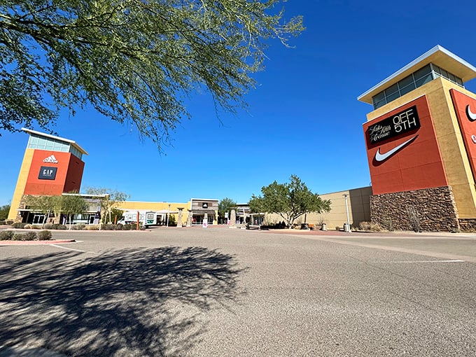 The grand entrance to shopping paradise, where those iconic brand towers stand like beacons of bargains against Arizona's impossibly blue sky.