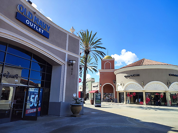 Spanish-style architecture under perfect San Diego skies – where Coach meets Old Navy and your wallet does a little happy dance.