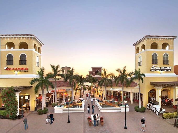 Mediterranean magic meets retail therapy at Miromar's entrance plaza, where palm trees and warm architecture transport shoppers to a European coastal village with Florida sunshine.