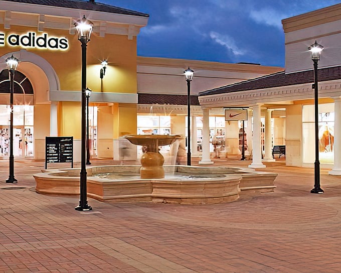 Mediterranean charm meets retail therapy at Orlando International Premium Outlets, where palm trees and terracotta roofs create the illusion you're not about to demolish your credit card.