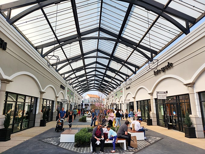 Timberland's storefront beckons with promises of rugged footwear while vibrant landscaping reminds you this isn't your average strip mall experience.