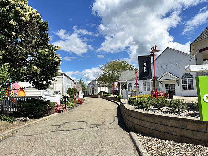 Blue skies welcome shoppers to Aurora Farms' charming New England-style pathways, where bargain hunting feels like a quaint village stroll.