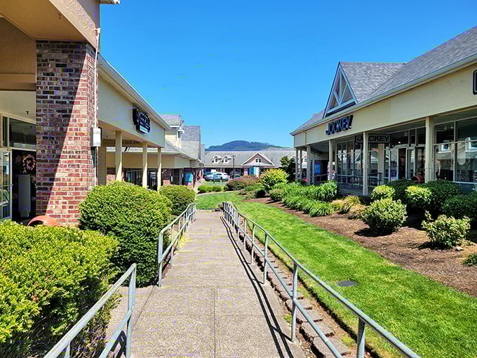 Manicured pathways and lush landscaping create an outdoor shopping experience that feels more like a coastal garden stroll than a bargain-hunting expedition.