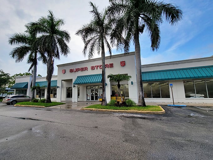 The iconic red shield welcomes treasure hunters under swaying Florida palms – a thrifter's paradise disguised as an unassuming storefront.