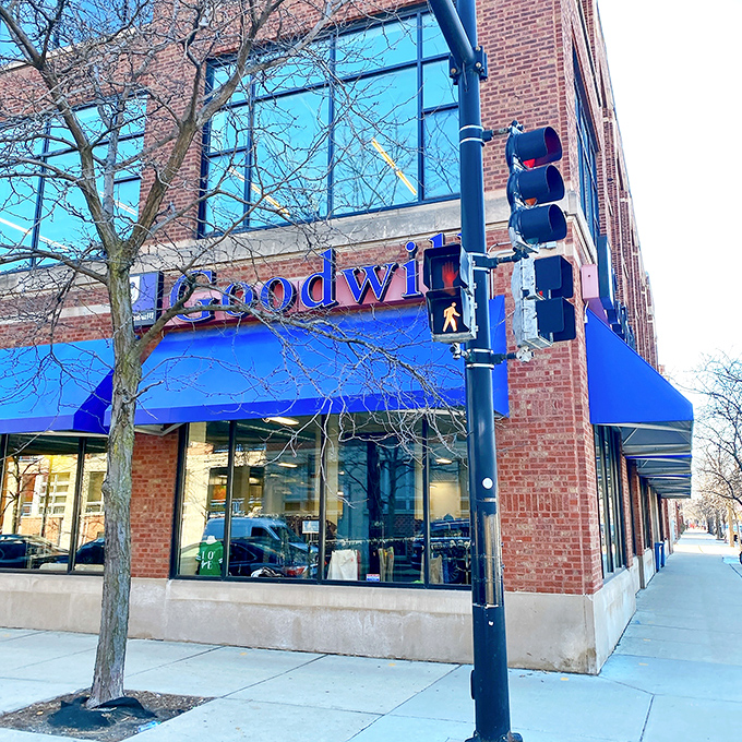 The iconic blue awning of Goodwill beckons bargain hunters like a retail lighthouse guiding ships to treasure-filled shores.
