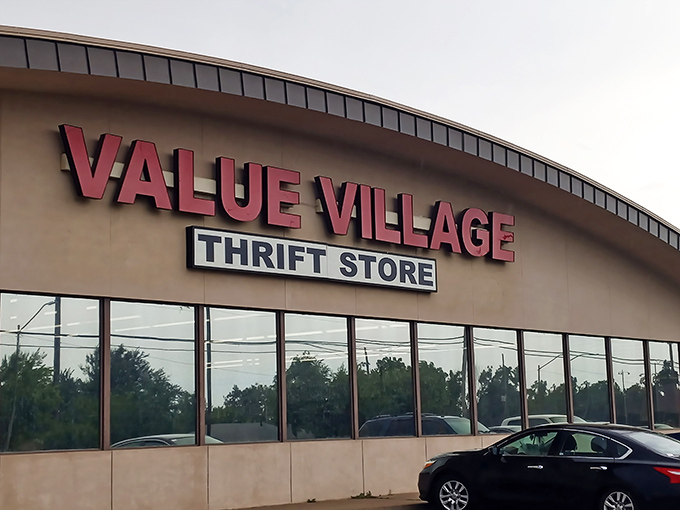 The iconic red lettering of Value Village beckons bargain hunters like a retail lighthouse in a sea of overpriced shopping options.