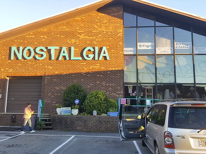The turquoise sign against brick is like a beacon for treasure hunters—Nostalgia's exterior promises adventures in time travel disguised as shopping.