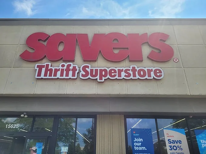 The bold red Savers sign beckons like a lighthouse for bargain hunters. This isn't just shopping—it's a treasure hunt with fluorescent lighting.