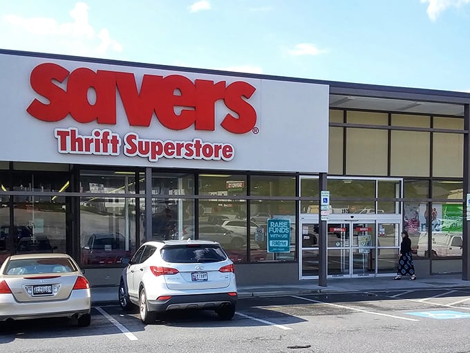 Morning sunshine illuminates the Savers storefront, where cars already gather like early birds determined to catch the worm—or in this case, the vintage leather jacket.