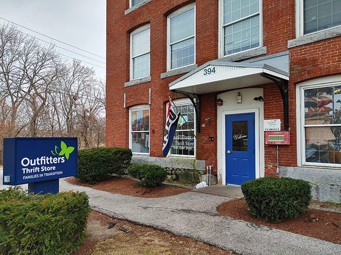 The iconic blue door of Outfitters Thrift Store beckons bargain hunters to this brick building treasure trove in Manchester, where wallet-friendly wonders await.