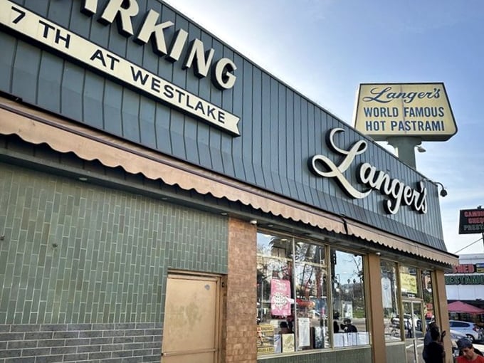 The iconic blue exterior of Langer's stands like a beacon of culinary hope at 7th and Westlake, promising pastrami perfection within.