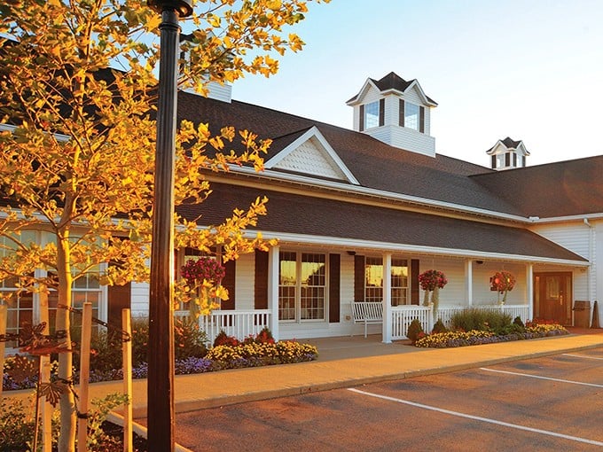 That golden autumn light hitting this farmhouse facade makes everything look like a Norman Rockwell painting come to life.