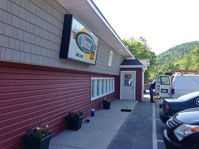 Diner 22's red siding and mountain backdrop create that perfect "pull over now" moment every road trip needs.