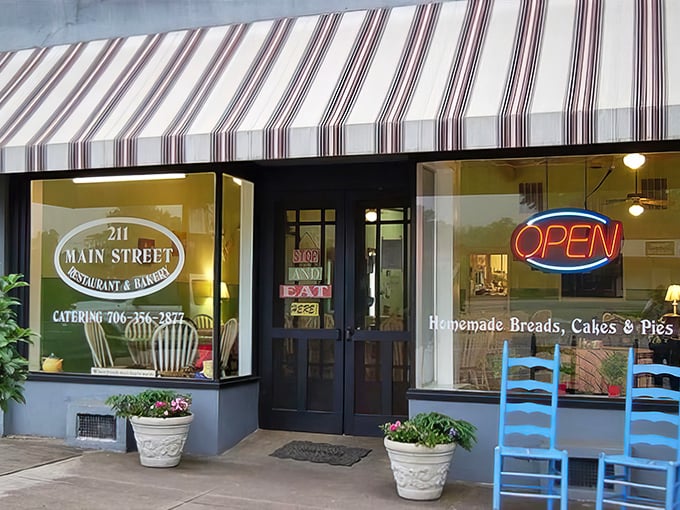 The charming storefront of 211 Main Street beckons with its purple trim and welcoming benches – like a small-town hug in architectural form.
