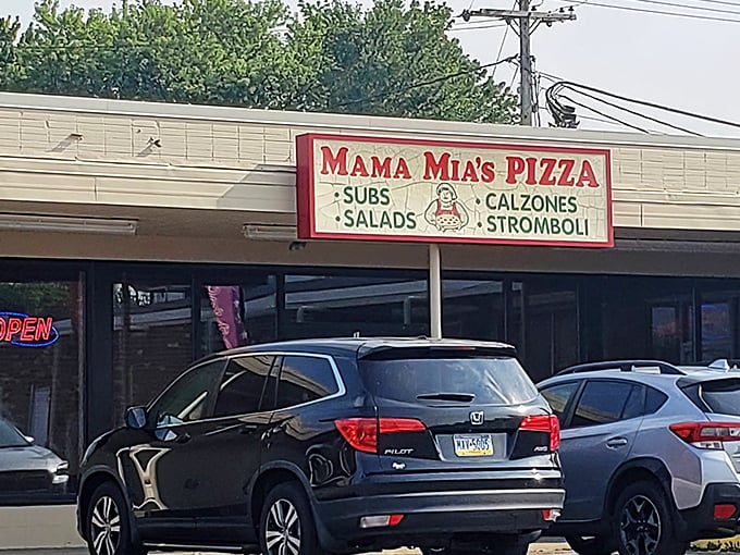 The unassuming storefront of Mama Mia's Pizza in Erie – where pizza pilgrimages begin and diet resolutions go to die.