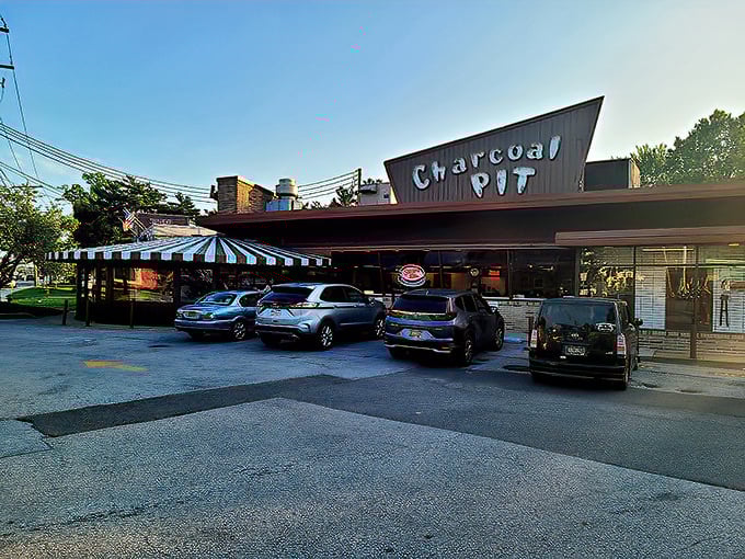 That distinctive blue-and-white striped awning has sheltered generations of diners heading in for their comfort food fix—Delaware's culinary time machine awaits beneath that iconic sign.