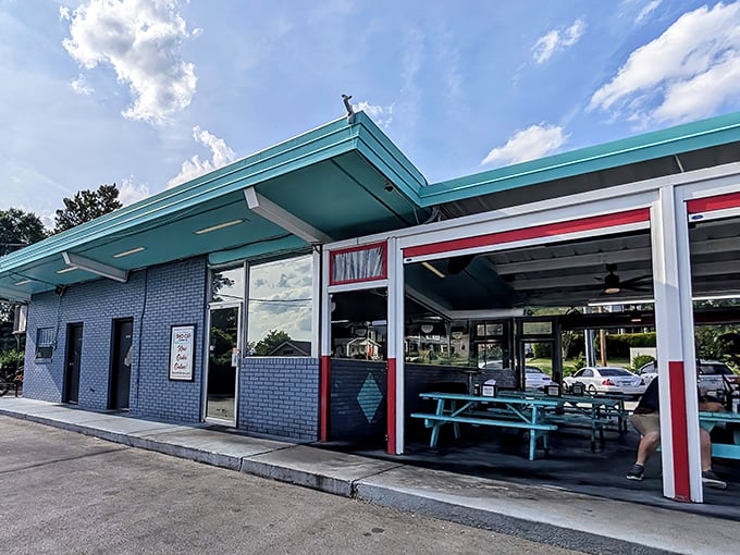 The turquoise roof and baby-blue brick exterior of Sno-Cap Drive-In stand out like a mid-century postcard come to life. Outdoor dining tables invite lingering conversations.
