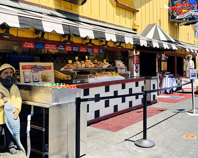 The cheerful yellow exterior of Old Fisherman's Grotto stands like a beacon on Monterey's wharf, promising seafood treasures within those striped-awning doors.