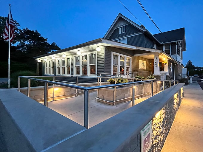 Jake's On Lake glows with twilight charm, its welcoming patio and classic blue siding promising lakeside comfort that feels like coming home.