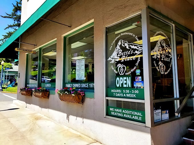 Bette's Place welcomes hungry travelers with cheerful flower boxes and that iconic green awning—Hood River's breakfast beacon against a backdrop of majestic mountains
