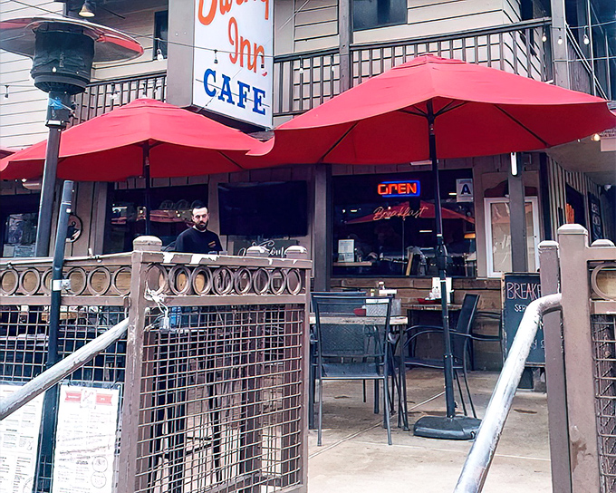 The iconic red umbrellas and vintage signage of Swing Inn Cafe welcome hungry travelers like a beacon of comfort food salvation in Old Town Temecula.