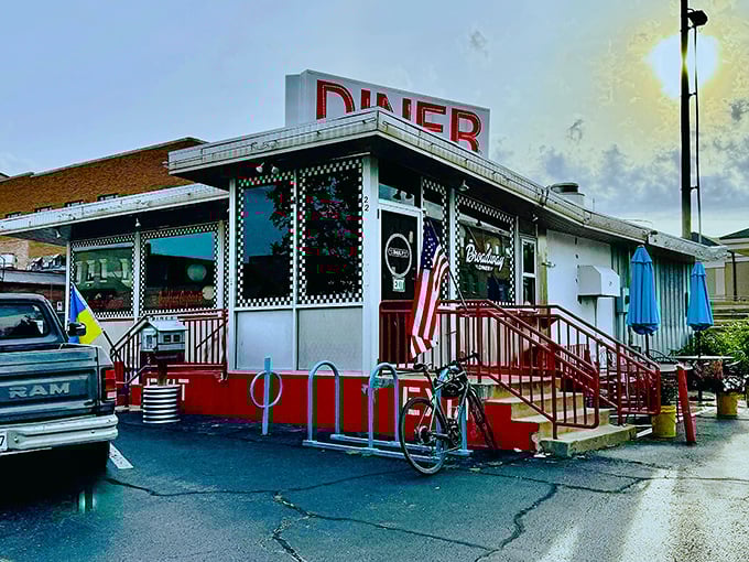 The classic American diner silhouette that promises comfort food salvation, complete with that iconic red trim and patriotic flair.