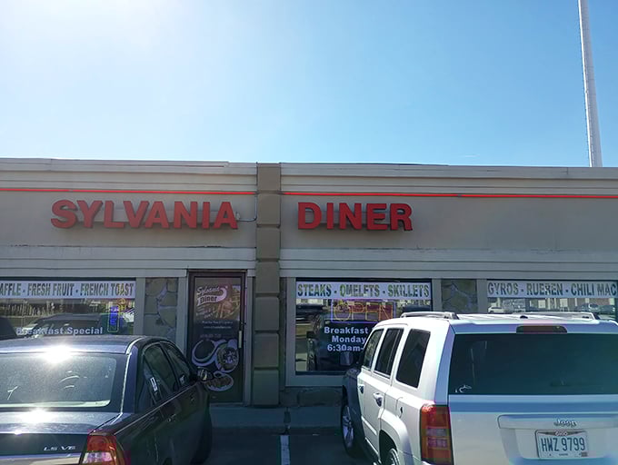 Bright red letters against a simple facade—like the diner equivalent of a Broadway marquee announcing today's performance: "Breakfast, served with no pretension."
