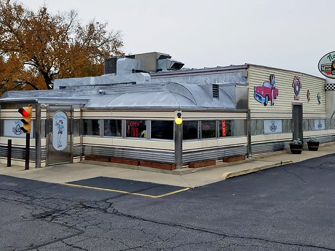 The classic silver diner car gleams in the Ohio sunshine, a time capsule of Americana complete with vintage car artwork that promises good eats inside.