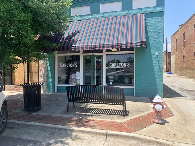 The mint-green facade with its classic striped awning isn't trying to impress anyone—it doesn't need to. The food does all the talking.