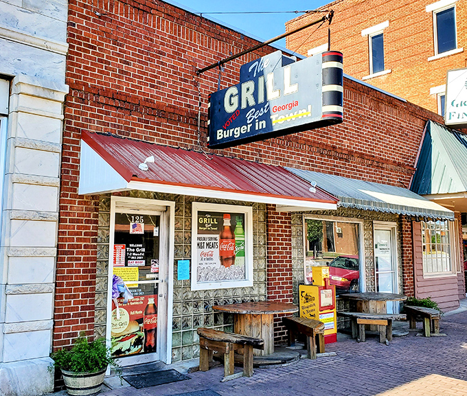 The brick facade and vintage sign of The Grill in Hawkinsville promises what every great roadside find should: the "Best Burger in Town" isn't just a claim—it's a mission statement.