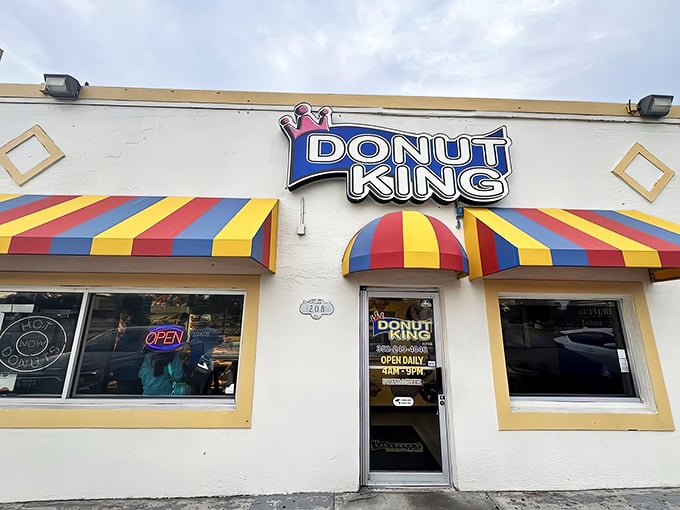 The colorful awnings of Donut King stand out like a beacon of sweetness on Highway 27, promising delicious treasures within.