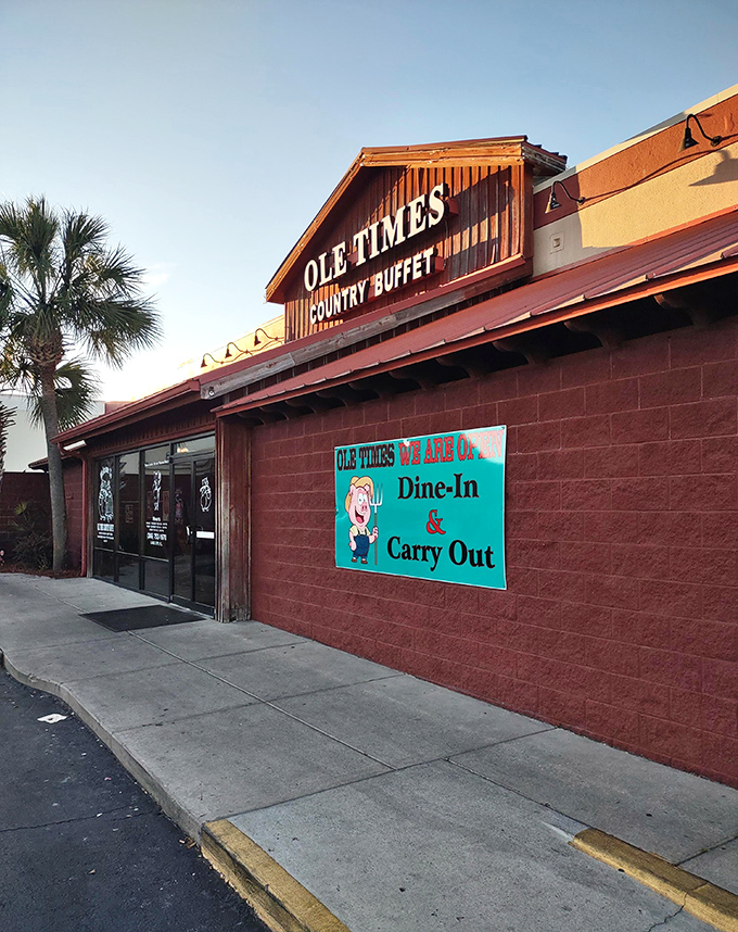 The rustic barn-like exterior of Ole Times Country Buffet promises what every road trip needs—comfort food that doesn't apologize for being exactly what it is.