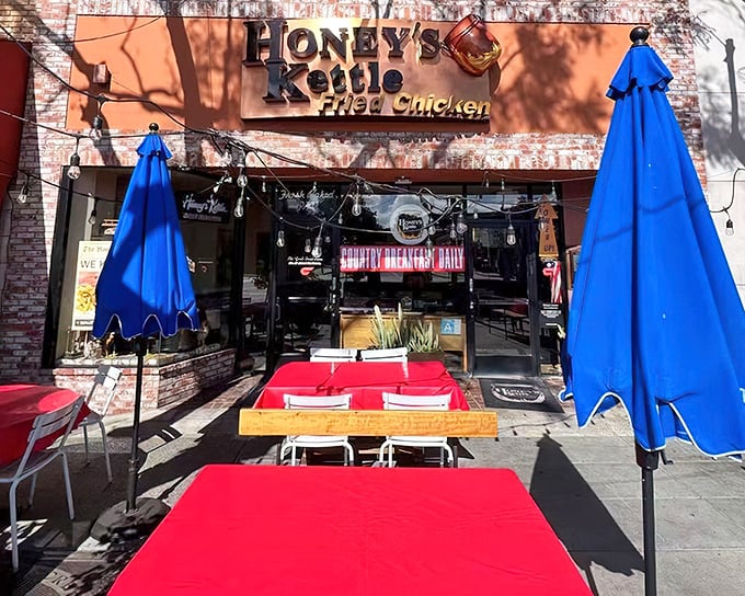 The blue umbrella beckons like a culinary lighthouse. Honey's Kettle's brick-faced exterior promises comfort food treasures within this Culver City gem.